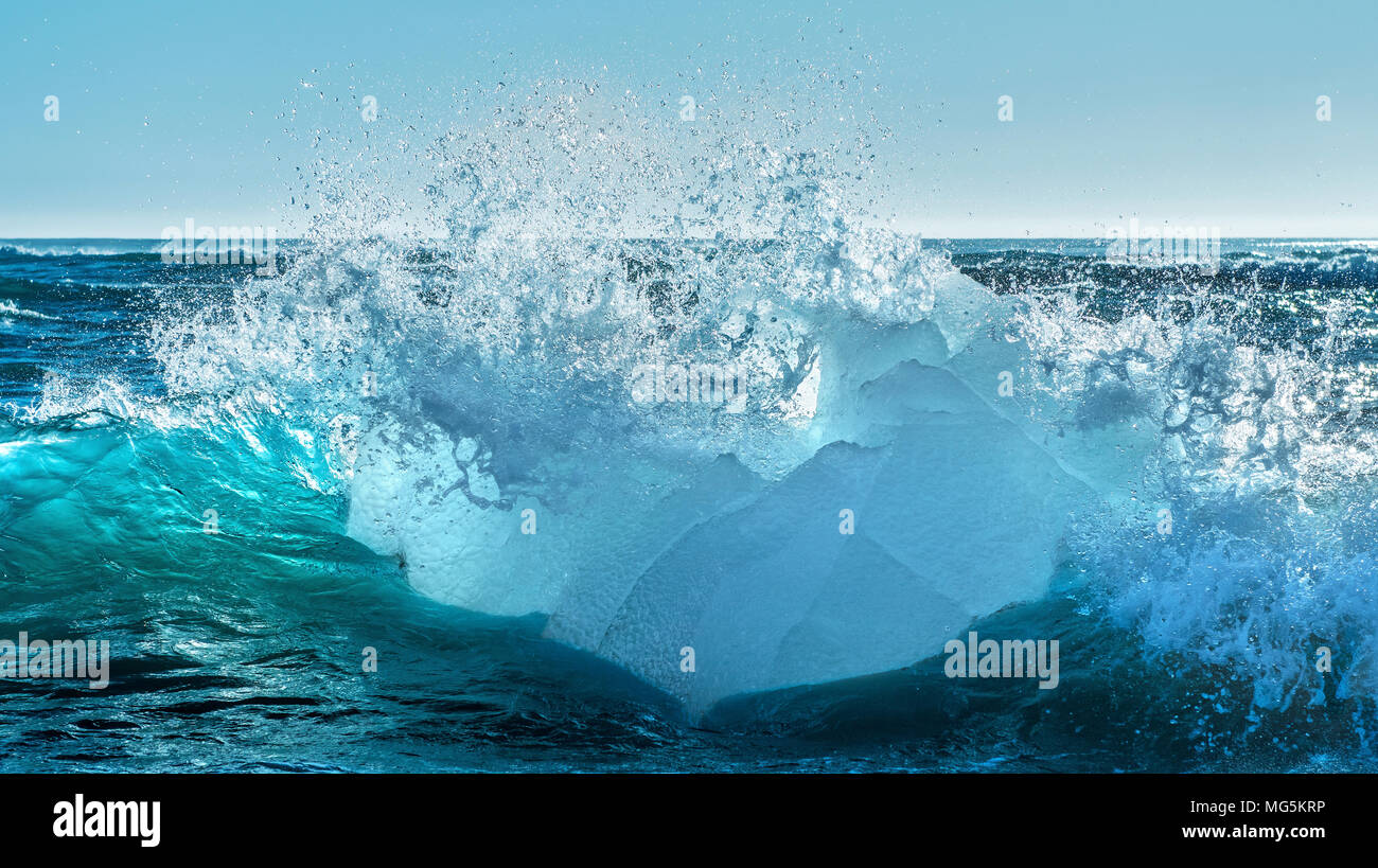 Waves crashing against iceberg in ICELAND Stock Photo - Alamy