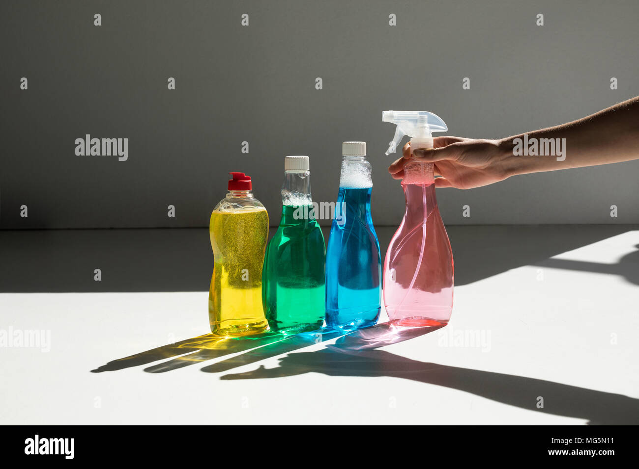 human hand and cleaning fluids Stock Photo - Alamy