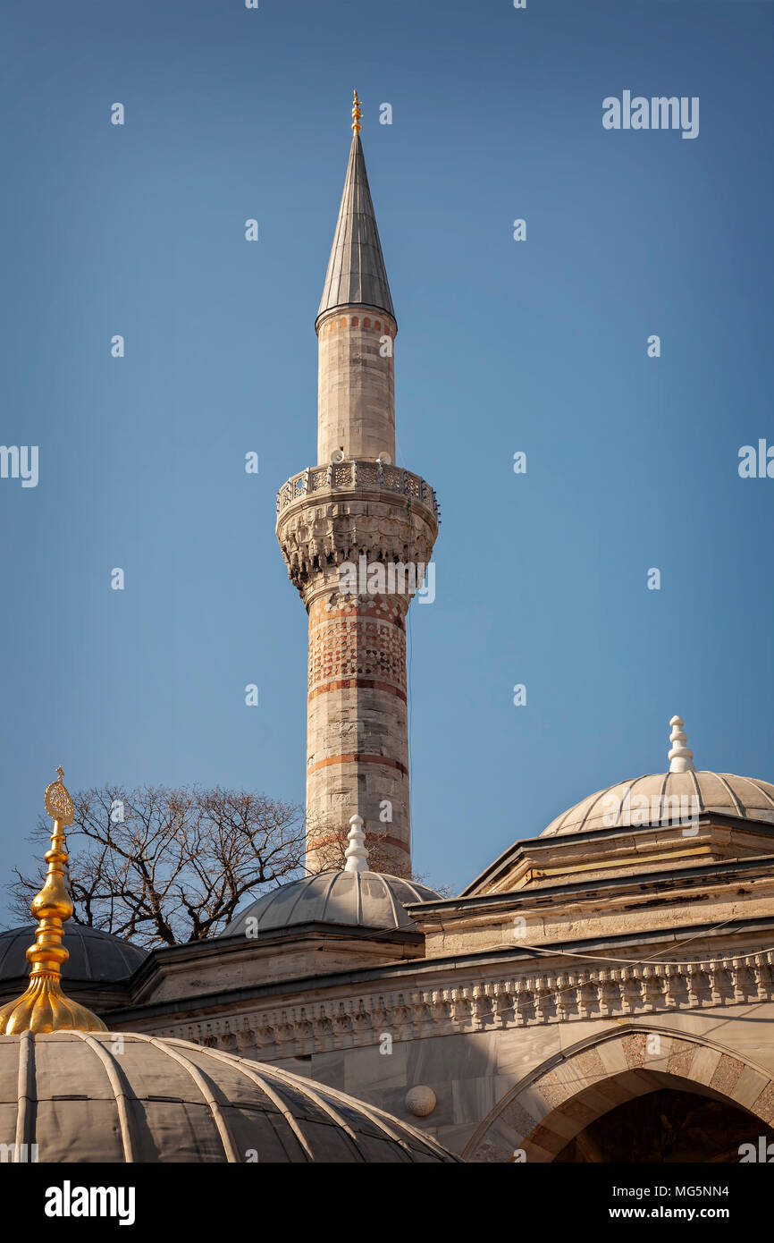 Tall minaret on mosque in Istanbul, Turkey. Blue sky background Stock ...