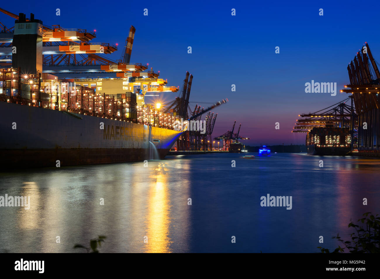 Container ship in the harbour at night. Container vessel at Terminal ...
