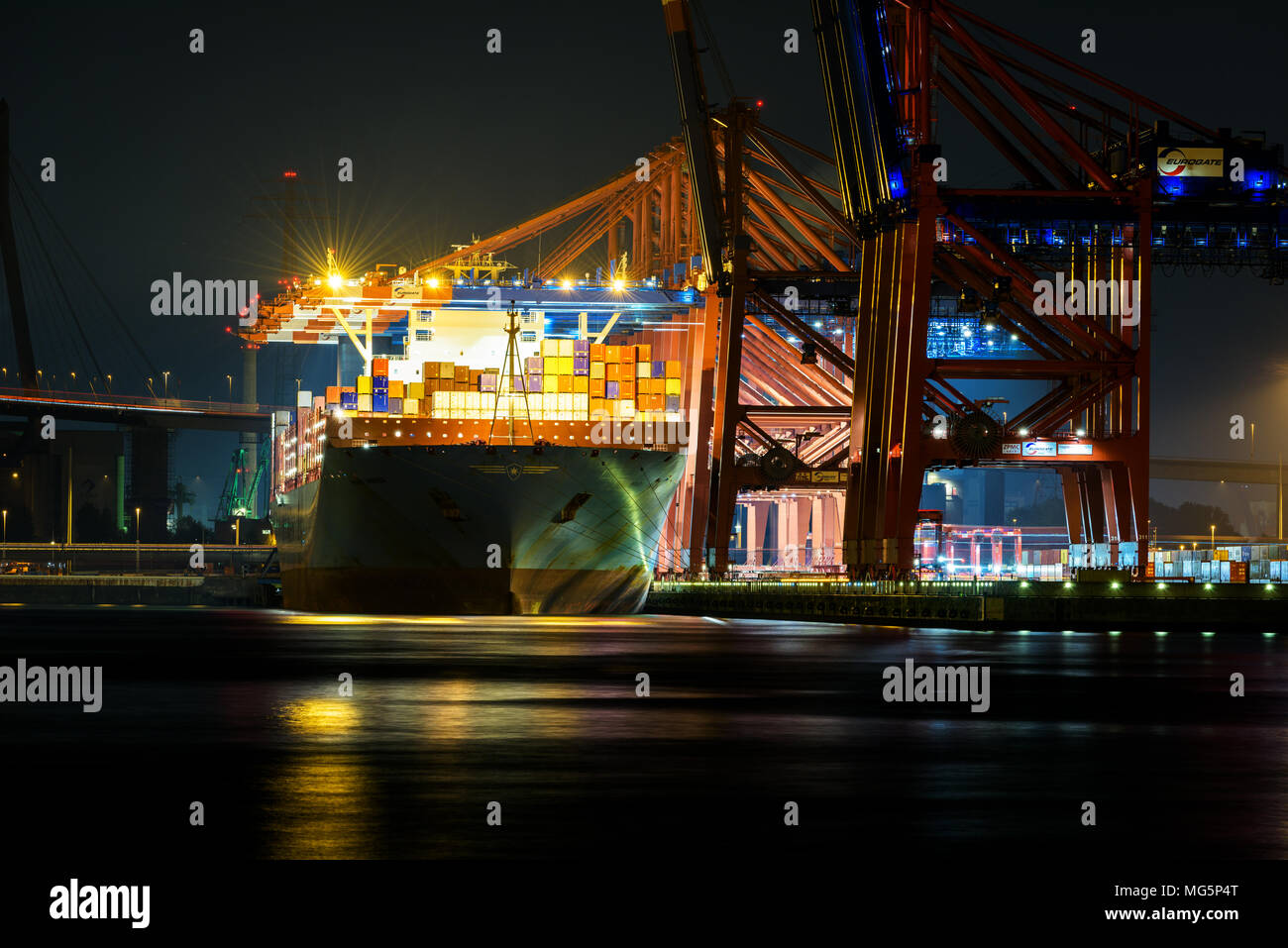 Container ship in the harbour at night. Container vessel at Terminal ...
