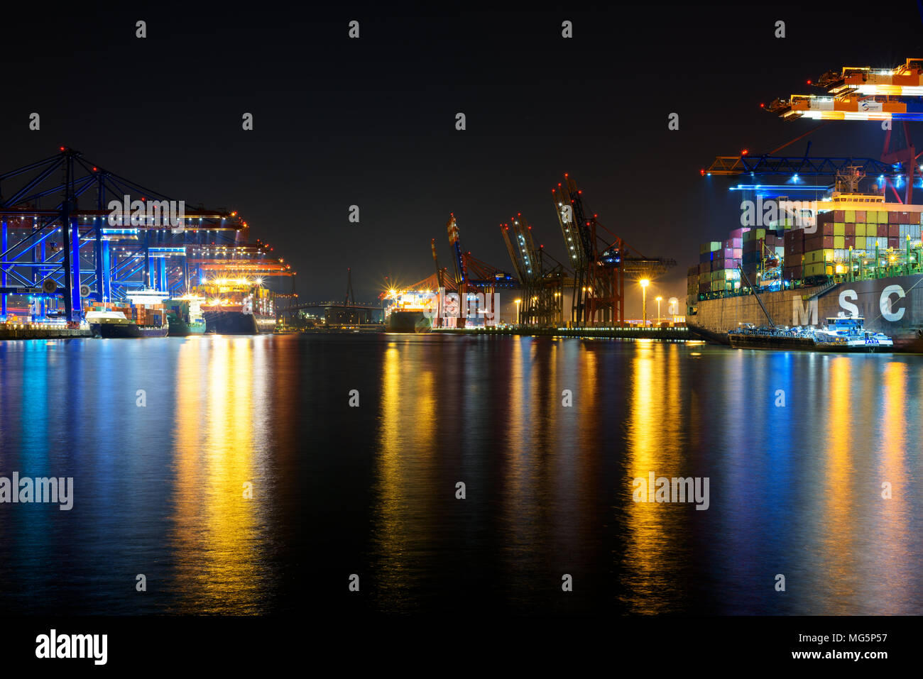 Container ship in the harbour at night. Container vessel at Terminal ...