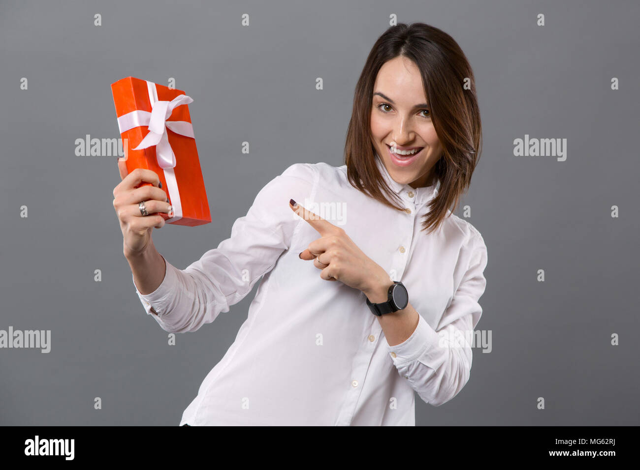 Joyful pleasant woman showing a present Stock Photo - Alamy