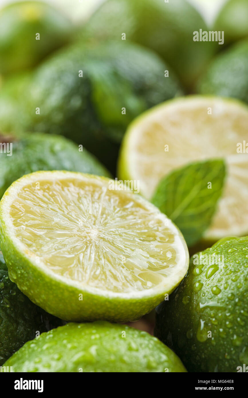 Wet limes and mint Stock Photo - Alamy