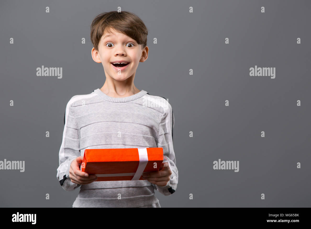 Joyful nice boy being happy about the present Stock Photo - Alamy