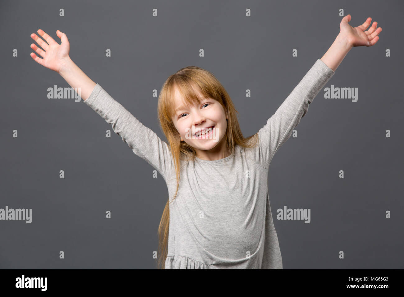 Happy joyful girl holding her hands up Stock Photo - Alamy