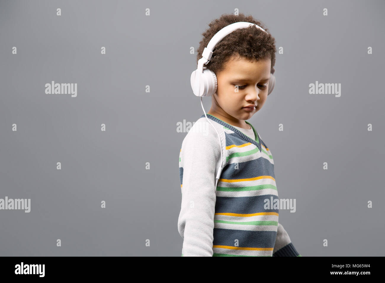 Nice cute boy listening to the song Stock Photo - Alamy