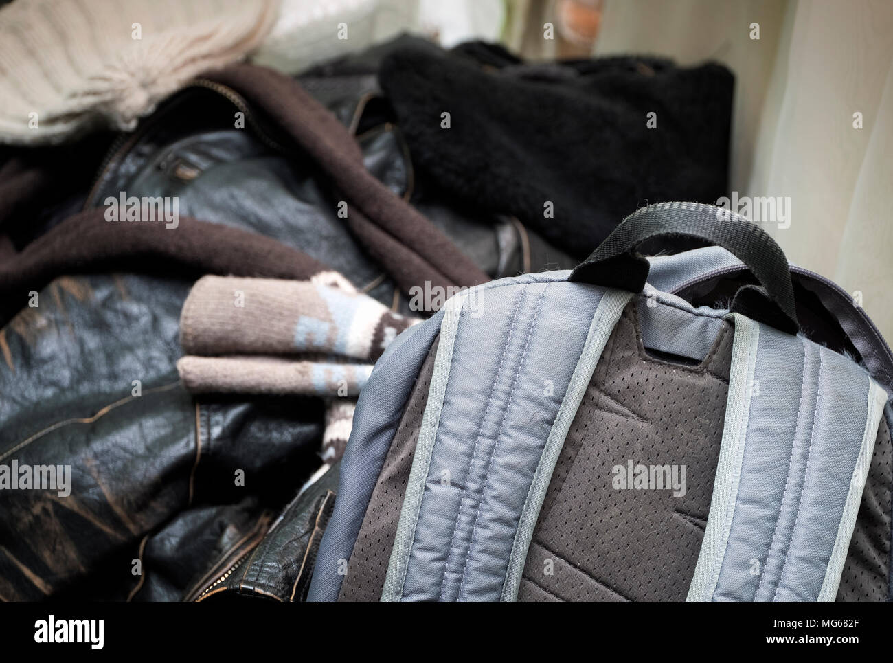 Cloesup of a rucksack and heap of clothes, indoor closeup Stock Photo ...