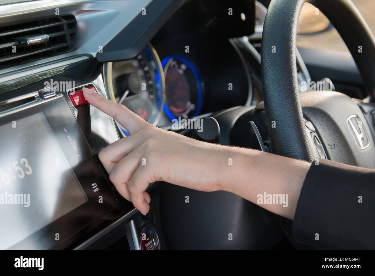 Business woman push emergency button in car, close up Stock Photo - Alamy