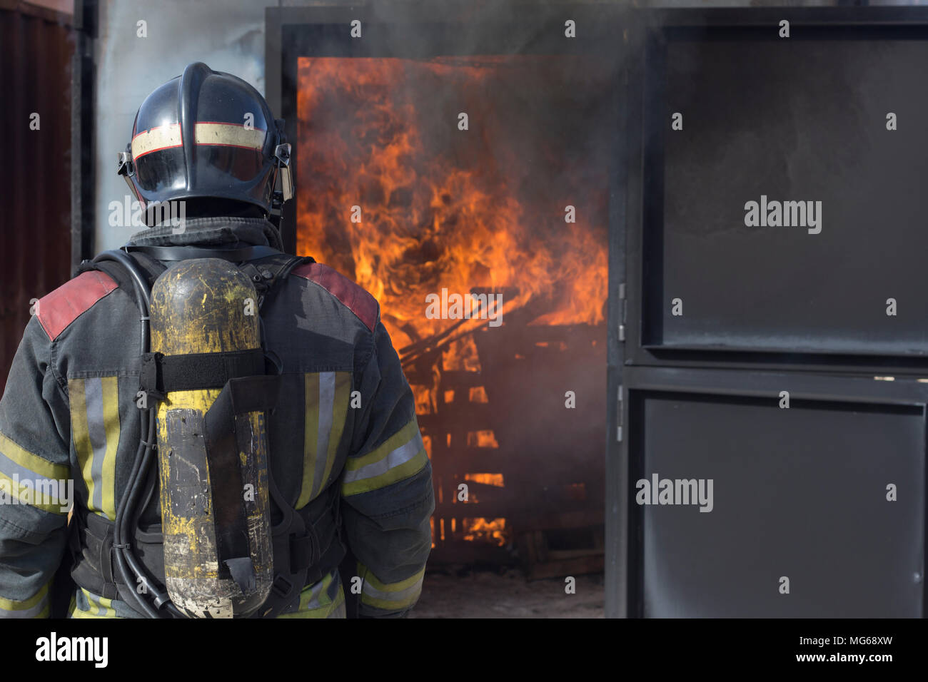 Firefighter putting out fire training station extinguisher backdraft ...