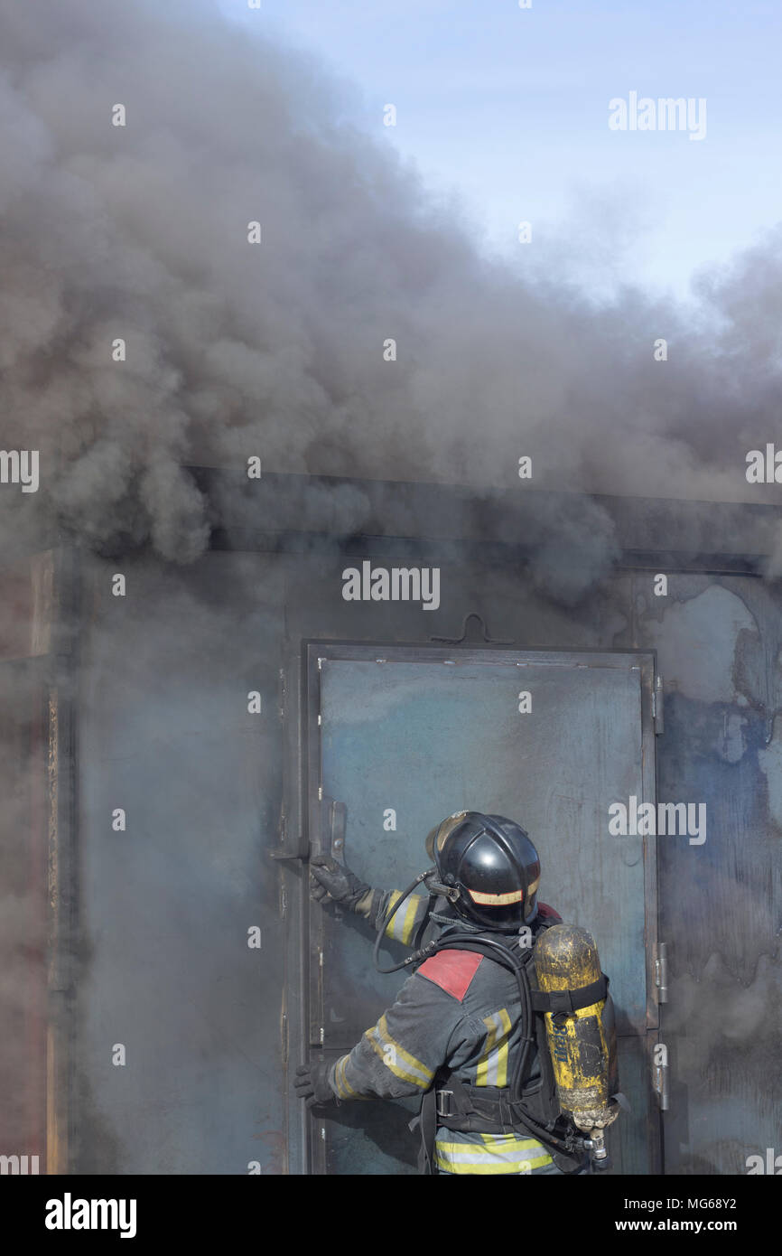 Firefighter putting out fire training station extinguisher backdraft ...