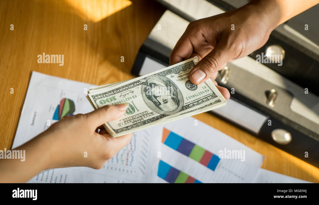 Business man hands handing money over a business dealing Stock Photo ...