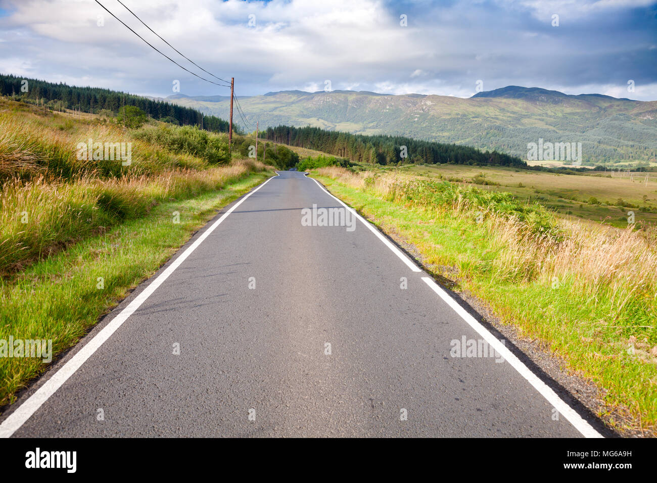 Summer landscape with straight one lane country road going through ...