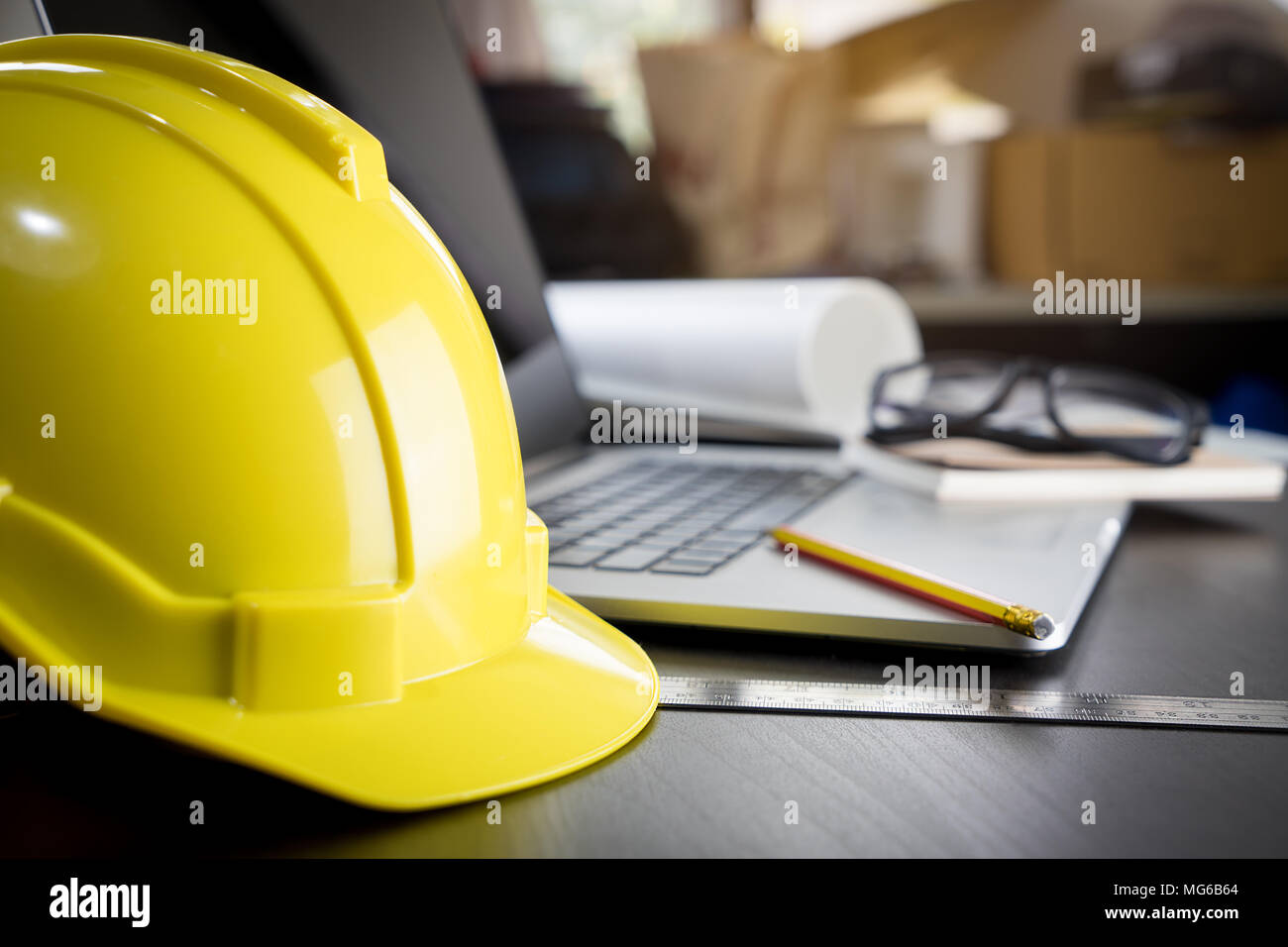 Engineering working desk with safty helmet Stock Photo - Alamy