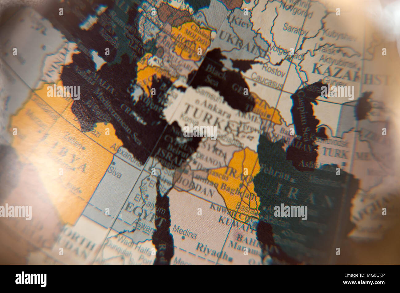 Focus on world map under magnifying glass Stock Photo - Alamy