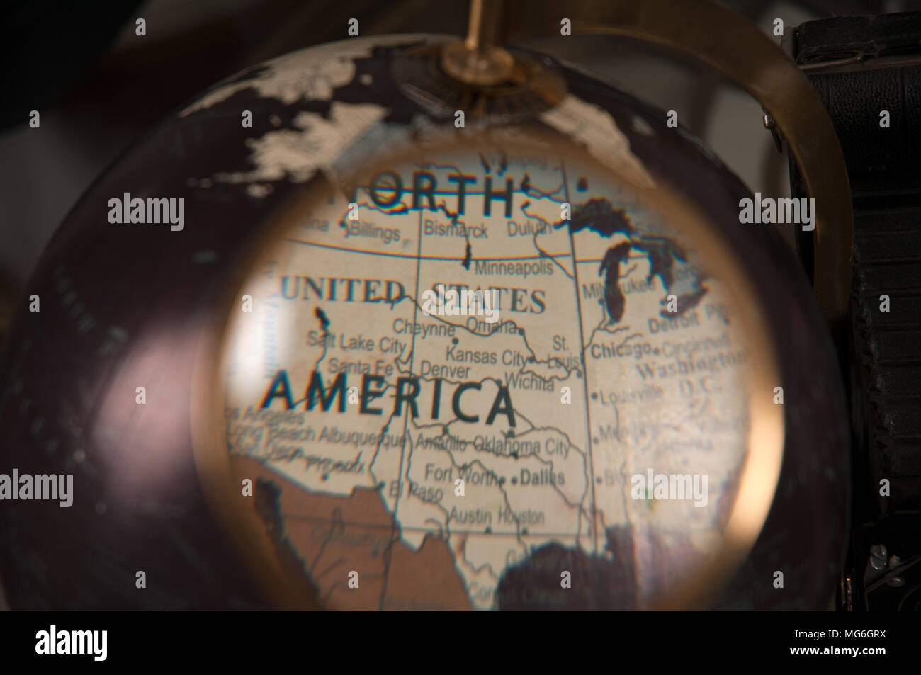 Focus on USA world map under magnifying glass Stock Photo - Alamy