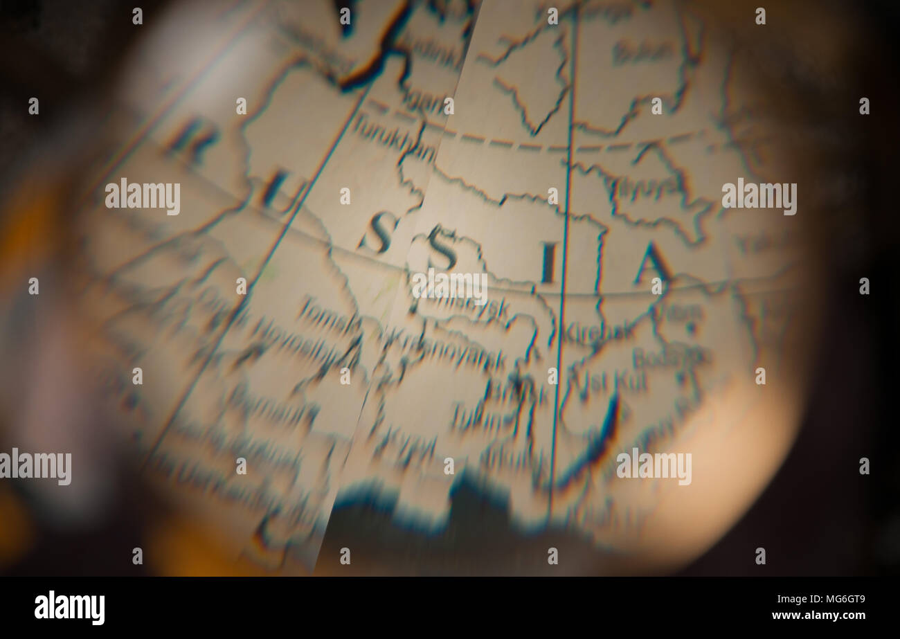 Focus on Russia world map under magnifying glass Stock Photo - Alamy