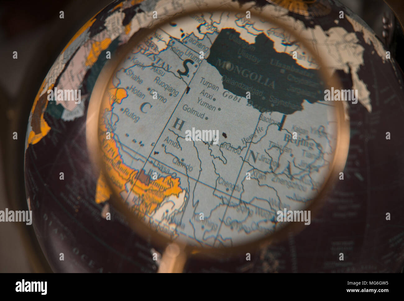 Focus on China world map under magnifying glass Stock Photo - Alamy