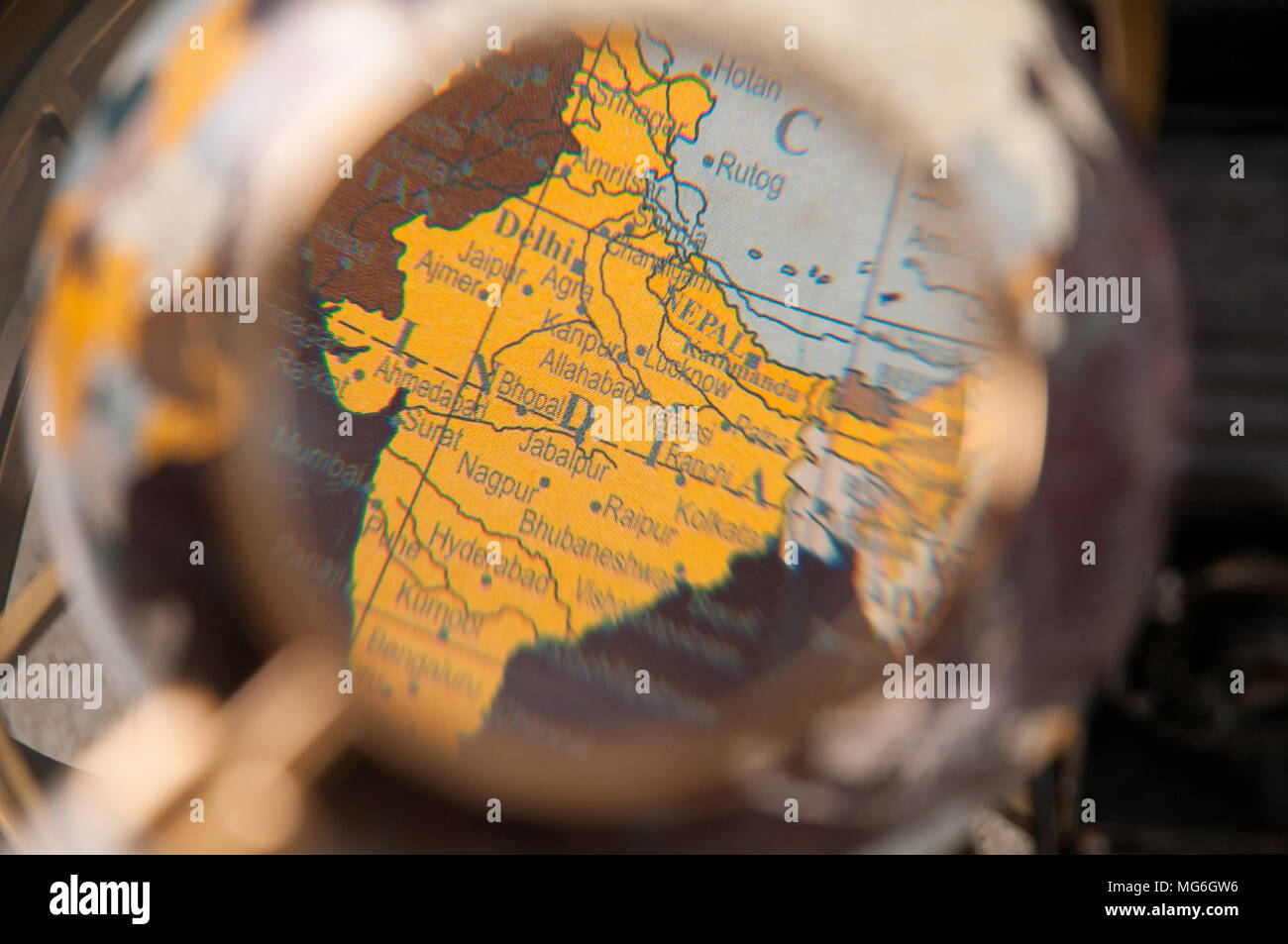 Focus on India world map under magnifying glass Stock Photo - Alamy