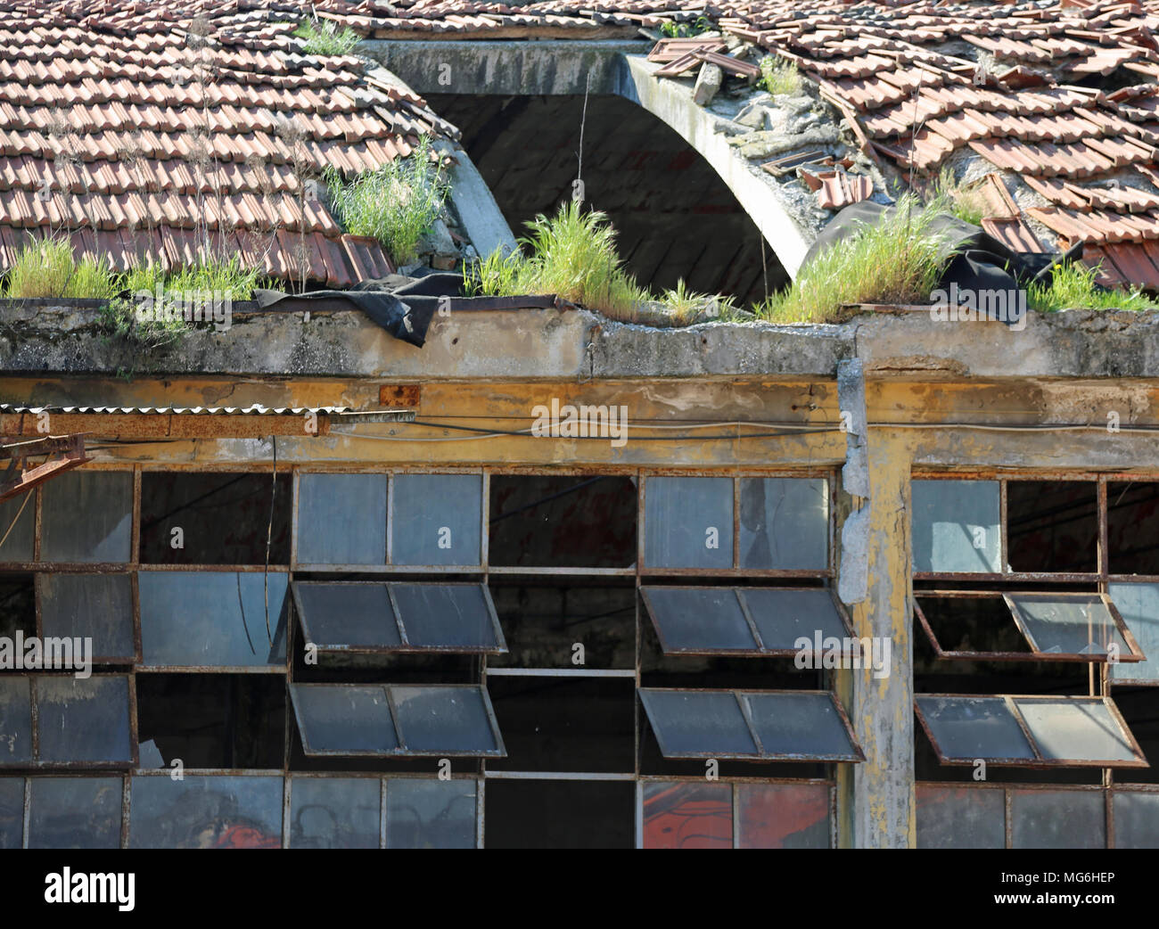 destroyed factory with broken roof and many windows without glass Stock ...
