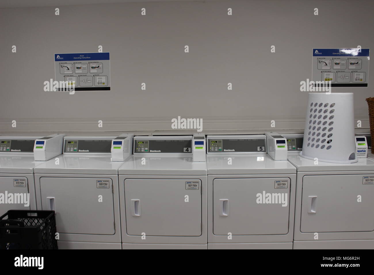 Powerful laundry machines and automatic dryers in big laundromat with a ...