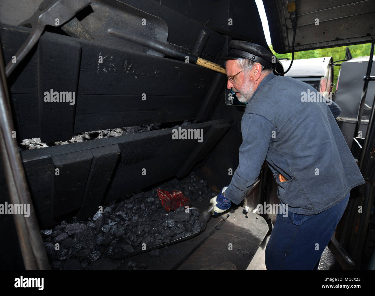 27 April 2018, Germany, Trier: Stoker Heizer Harald throwing coal into ...