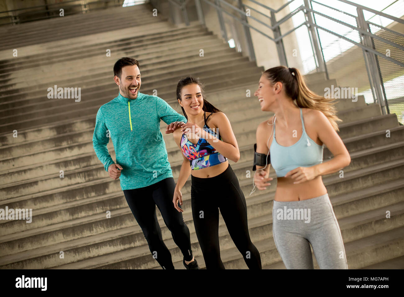 Young people running outdoor along stairs Stock Photo - Alamy