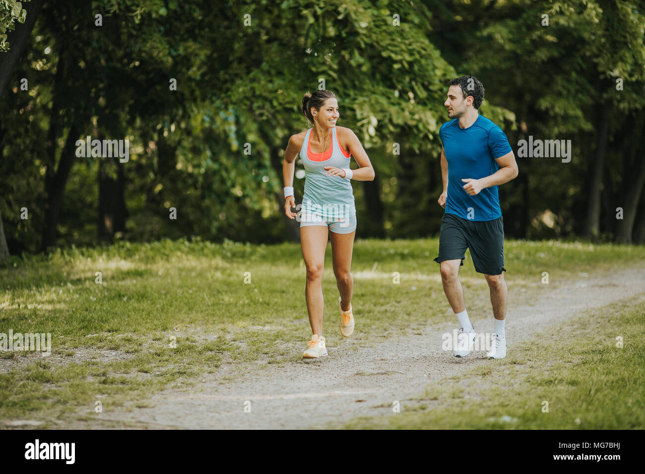 Young people jogging and exercising in nature at sunny day Stock Photo ...