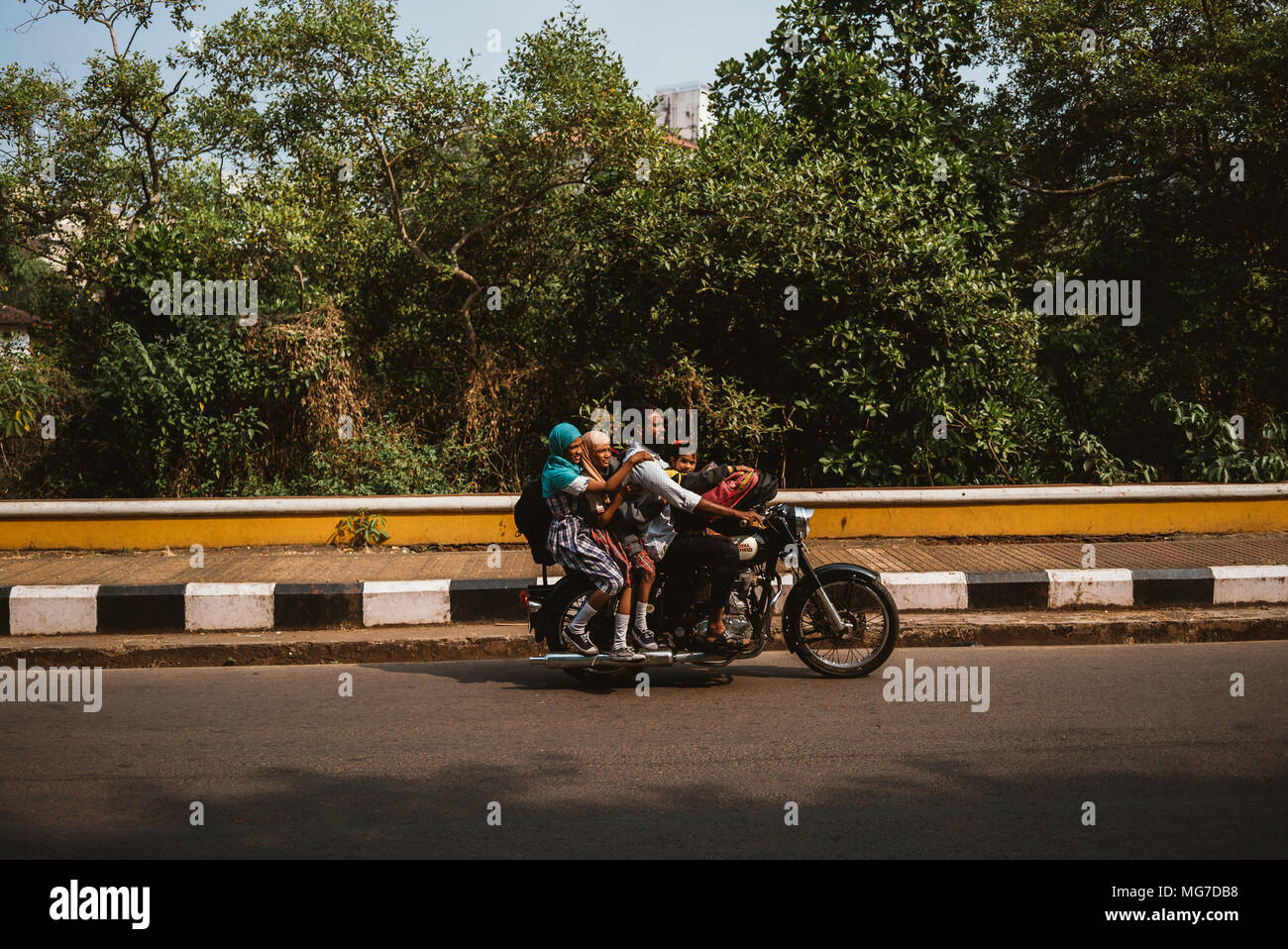 a family on a motorcycle heading to school and work in goa, India Stock ...