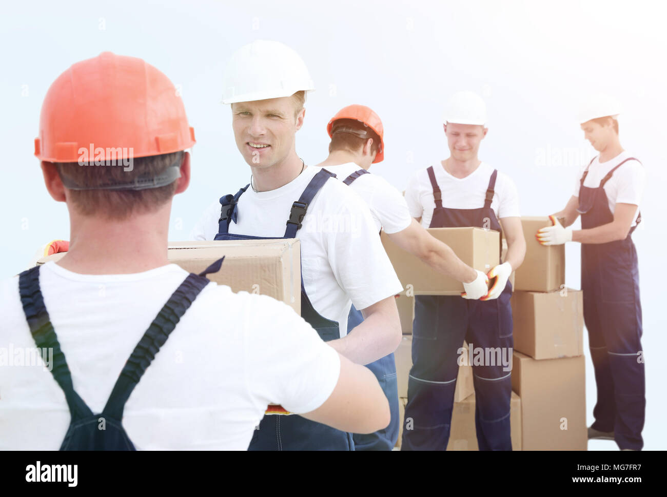 Group of people builders with boxes Stock Photo - Alamy