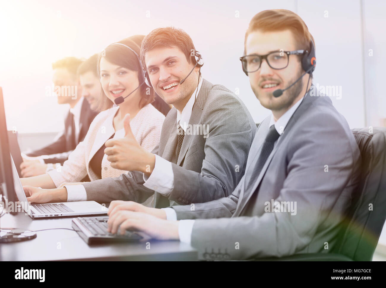 employee call center with headset showing thumb up Stock Photo - Alamy