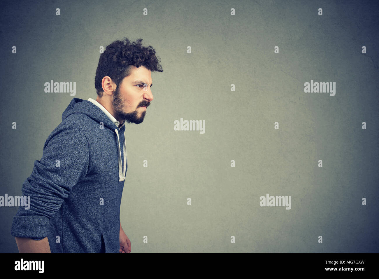Angry annoyed man on wall background Stock Photo - Alamy