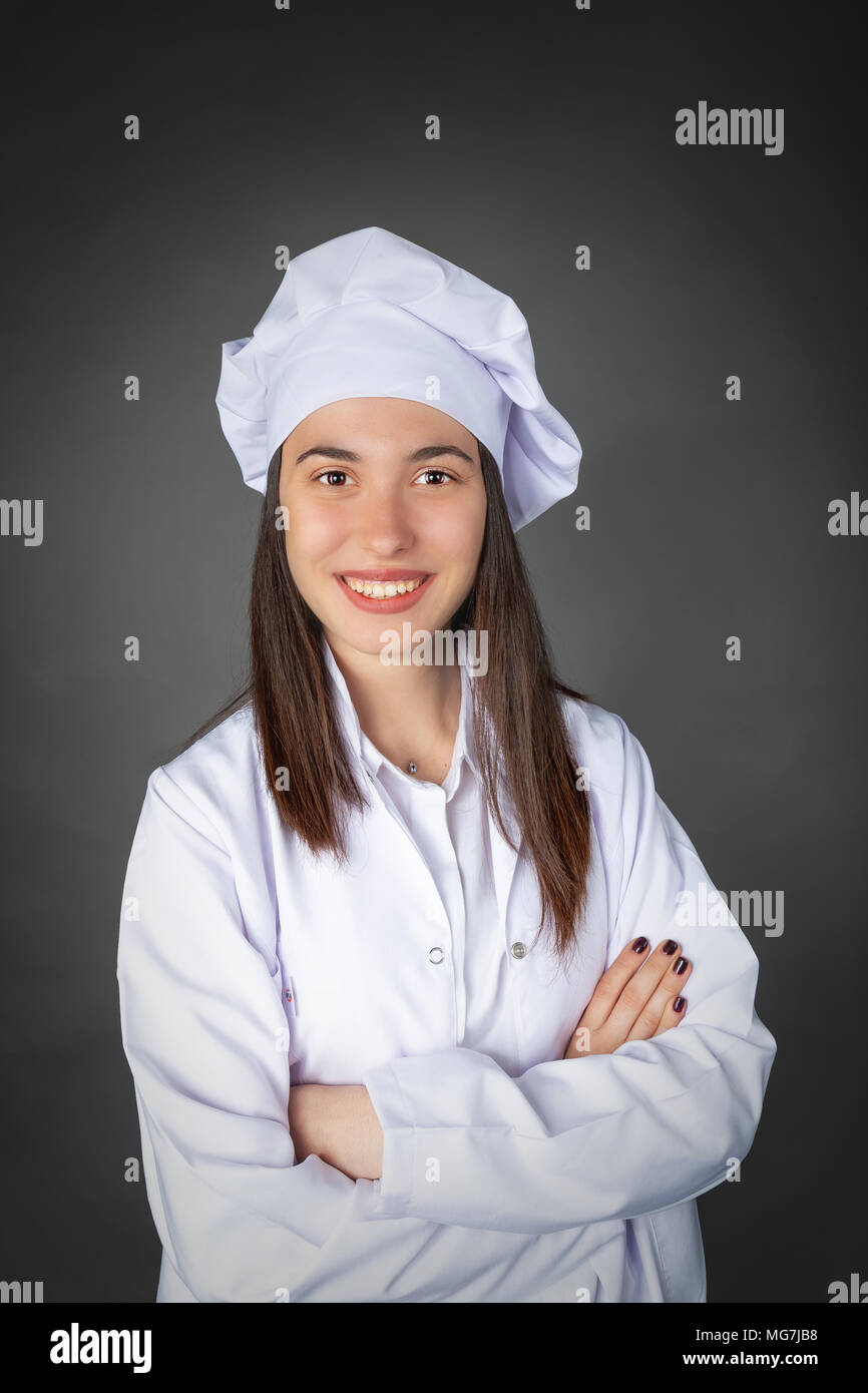 Beautiful Turkish smiling young female chef with confident expression ...
