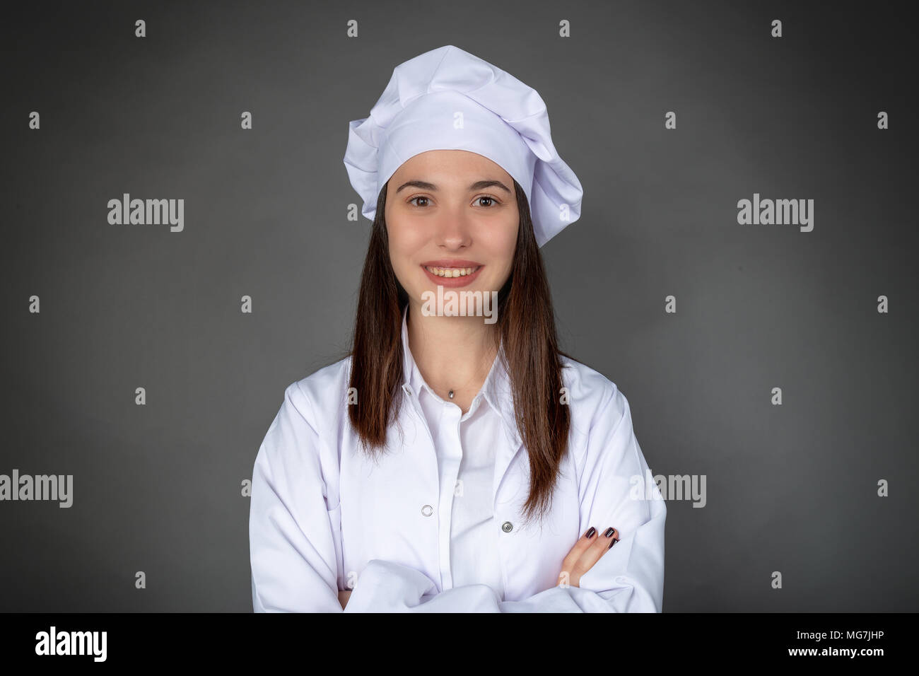 Beautiful Turkish smiling young female chef with confident expression ...