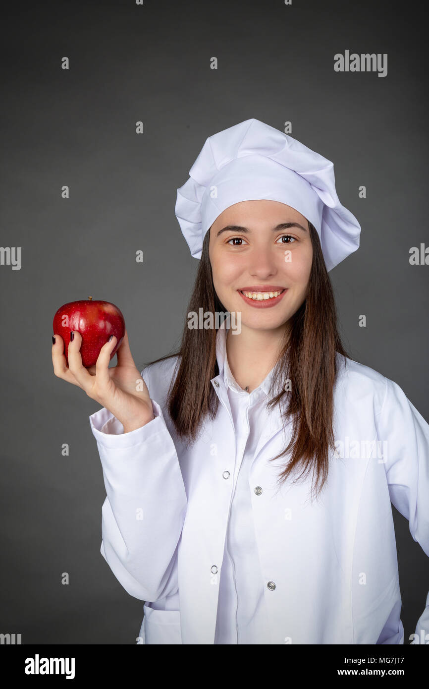 Beautiful Turkish young female chef keeping an apple on her hand Stock ...