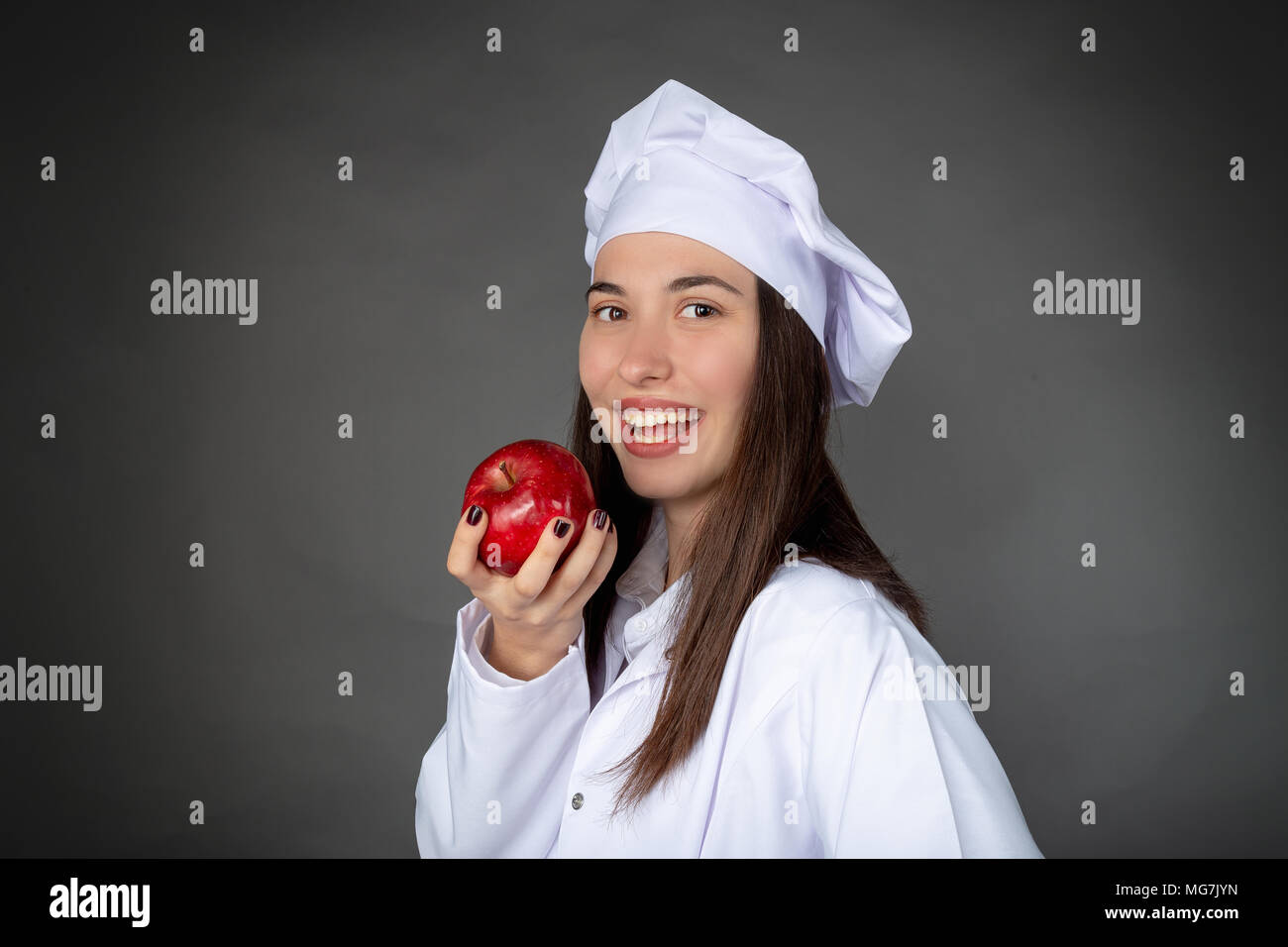Beautiful Turkish young female chef keeping an apple on her hand Stock ...