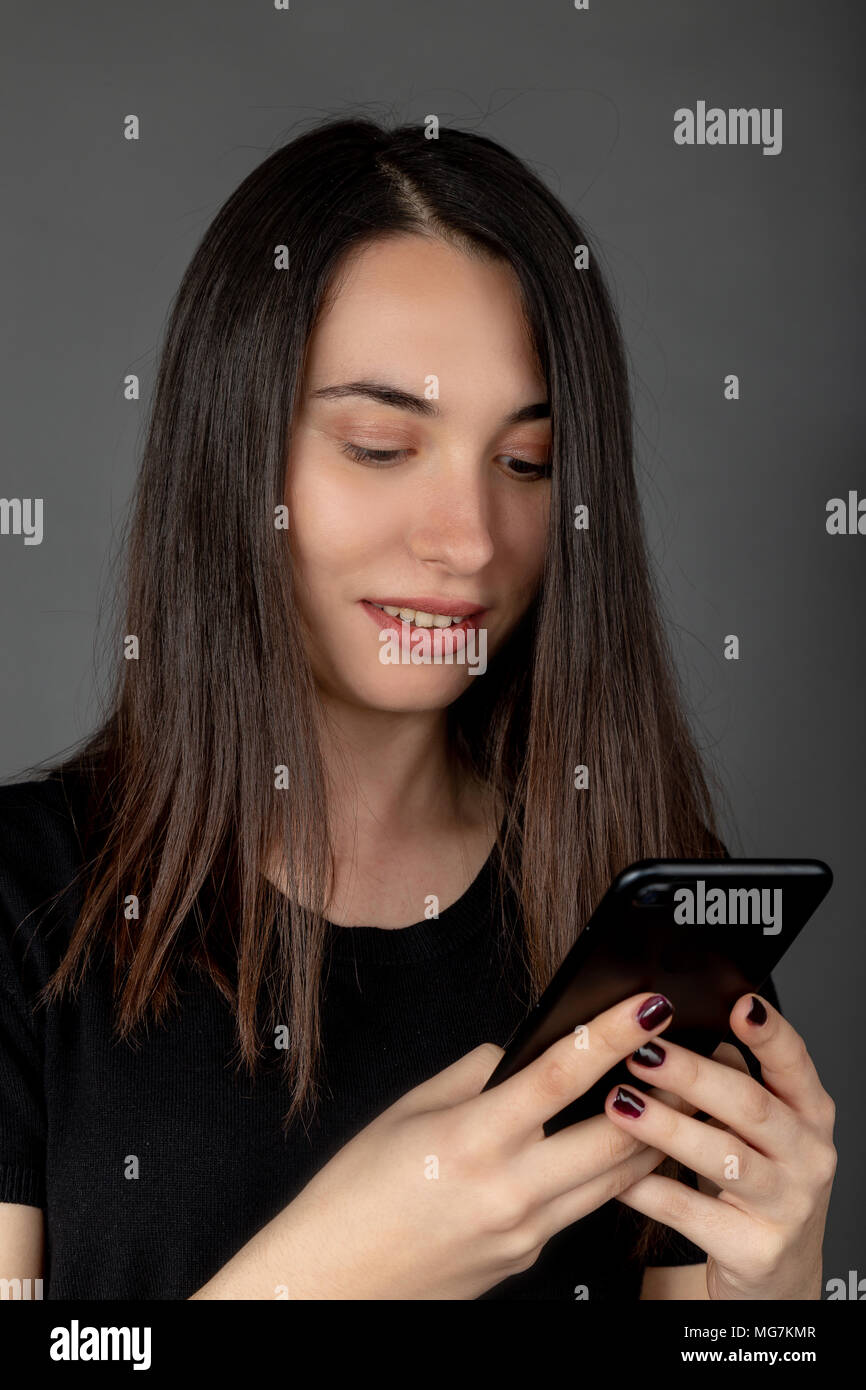 Beautiful young Turkish girl keeping and typing a message Stock Photo ...