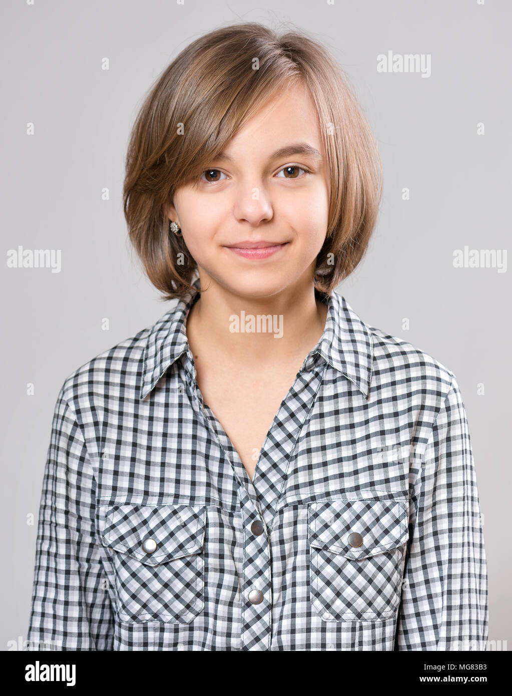 White teen girl looking up at camera and smiling hi-res stock ...
