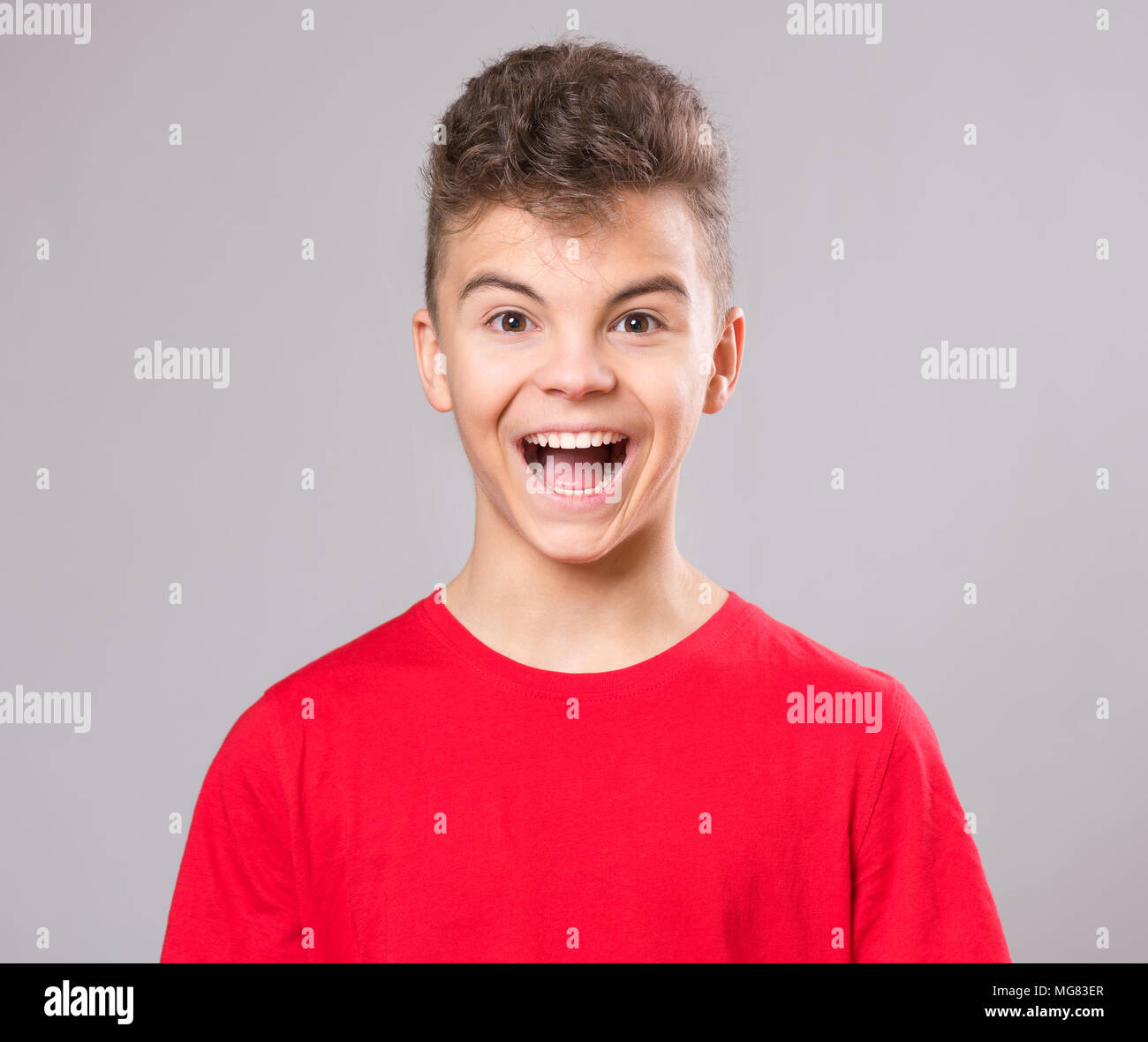 Close up emotional portrait of caucasian teen boy. Handsome smiling guy ...