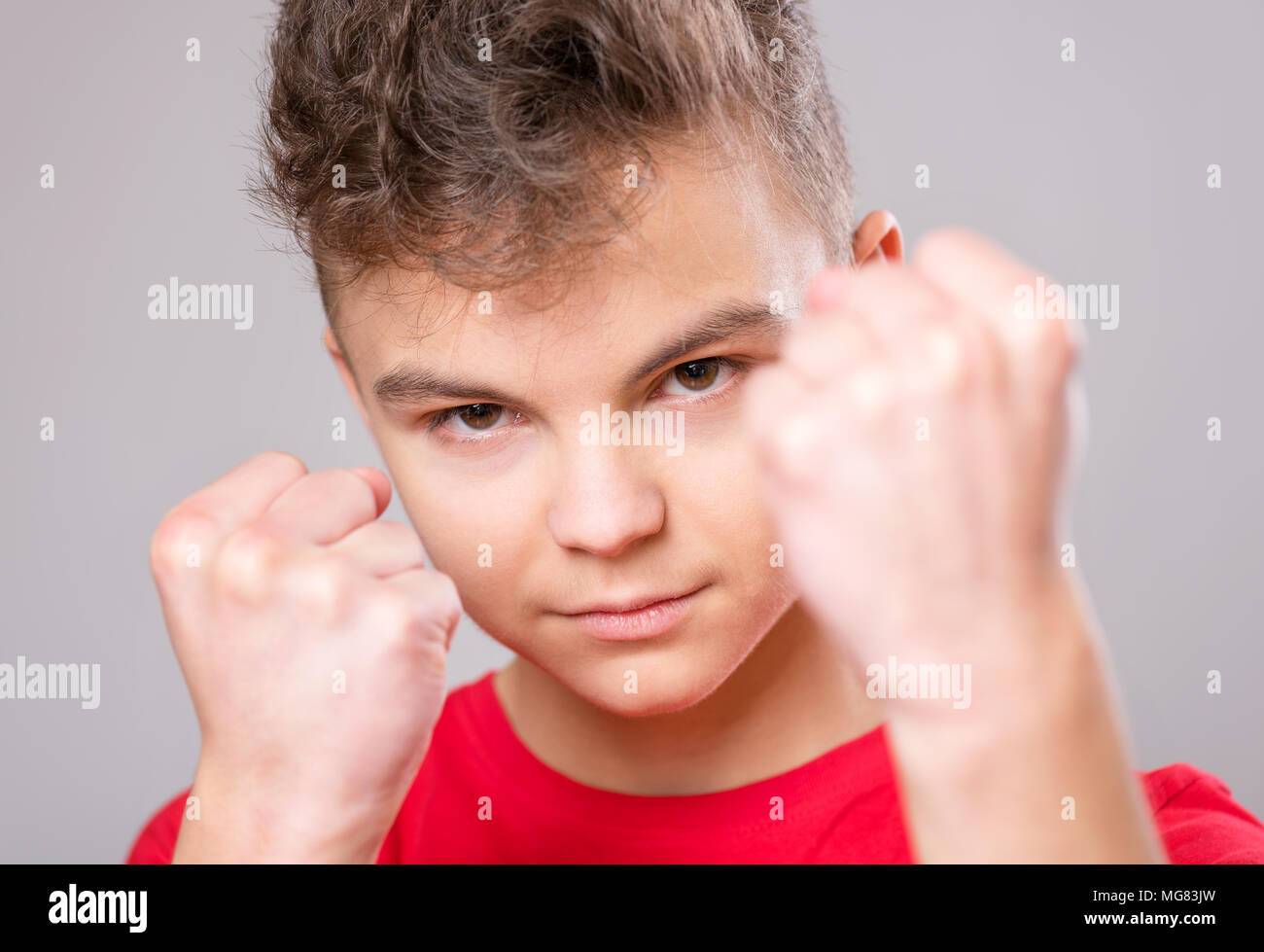 Emotional portrait of irritated teen boy. Furious teenager looking with ...