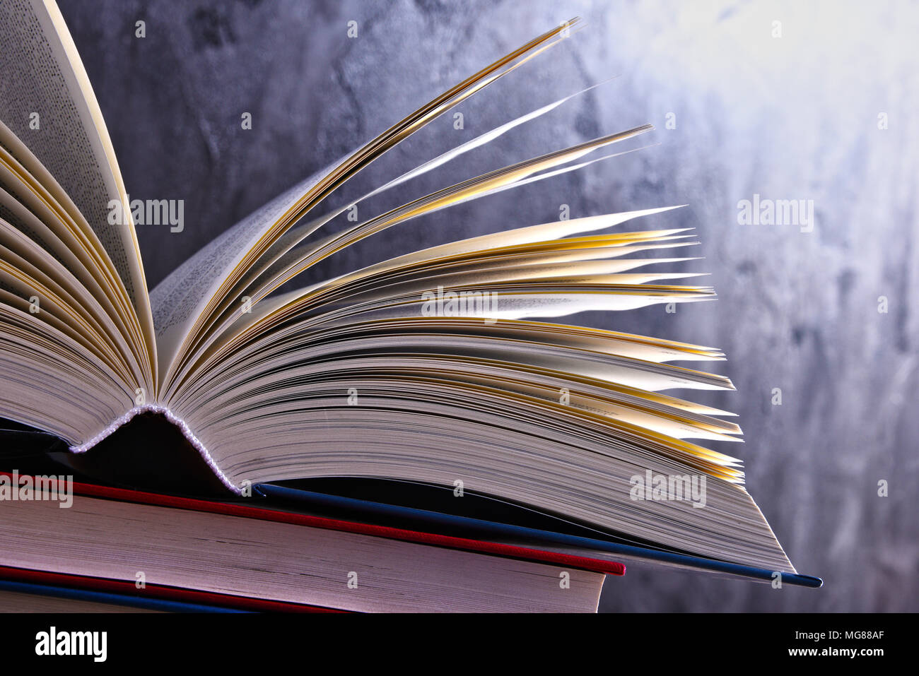 Composition with open book Stock Photo - Alamy