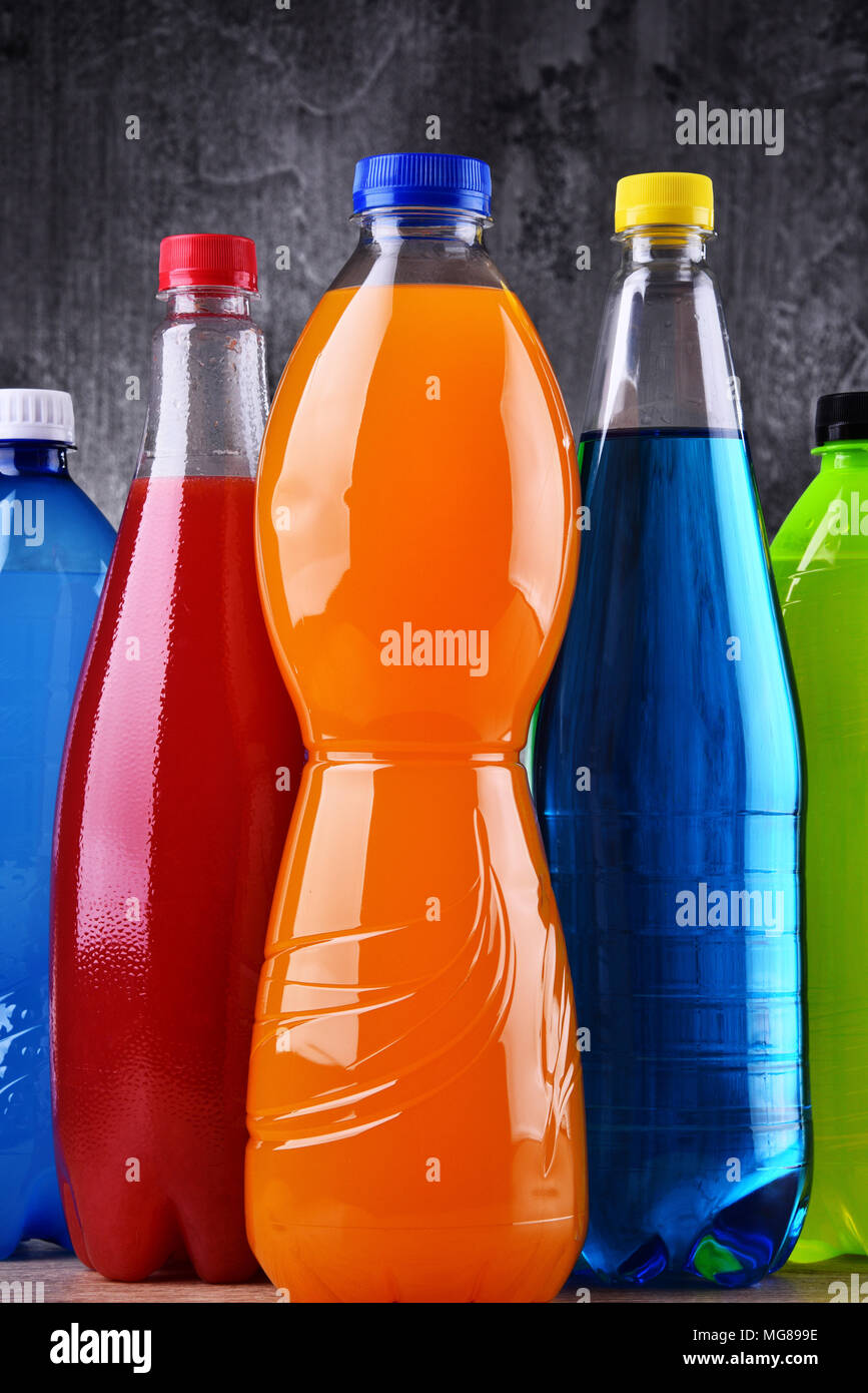Plastic bottles of assorted carbonated soft drinks in variety of colors ...