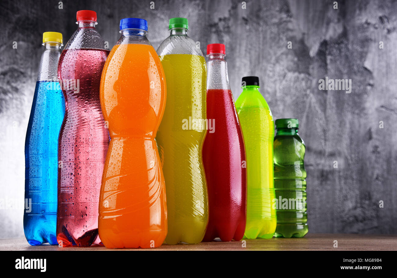 Plastic bottles of assorted carbonated soft drinks in variety of colors ...