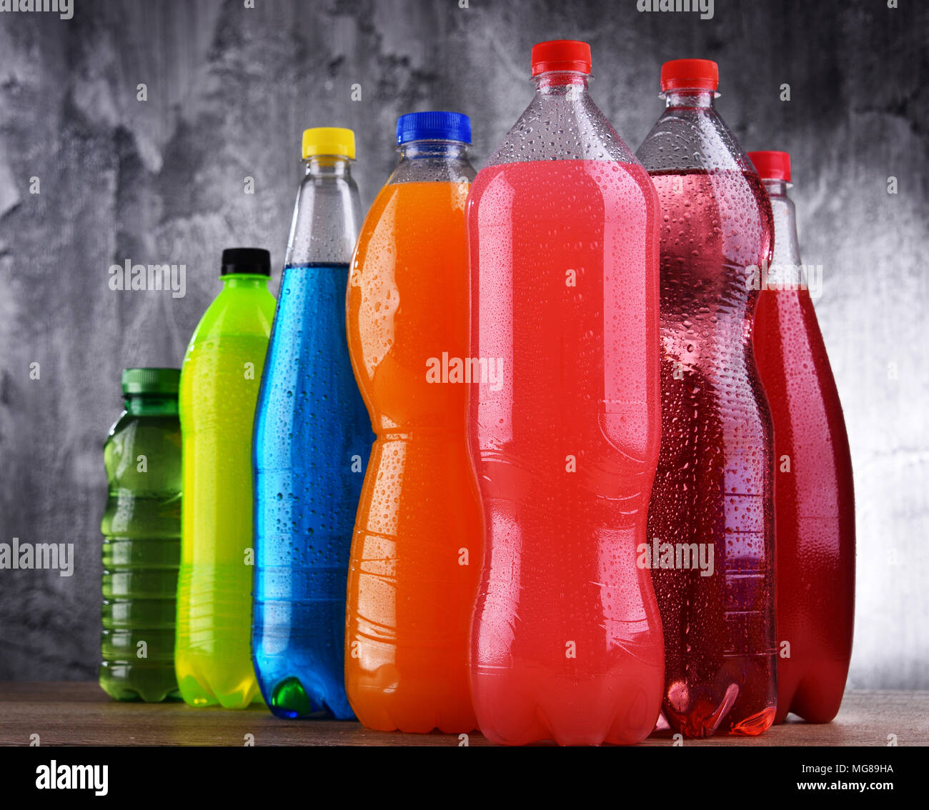 Plastic bottles of assorted carbonated soft drinks in variety of colors ...