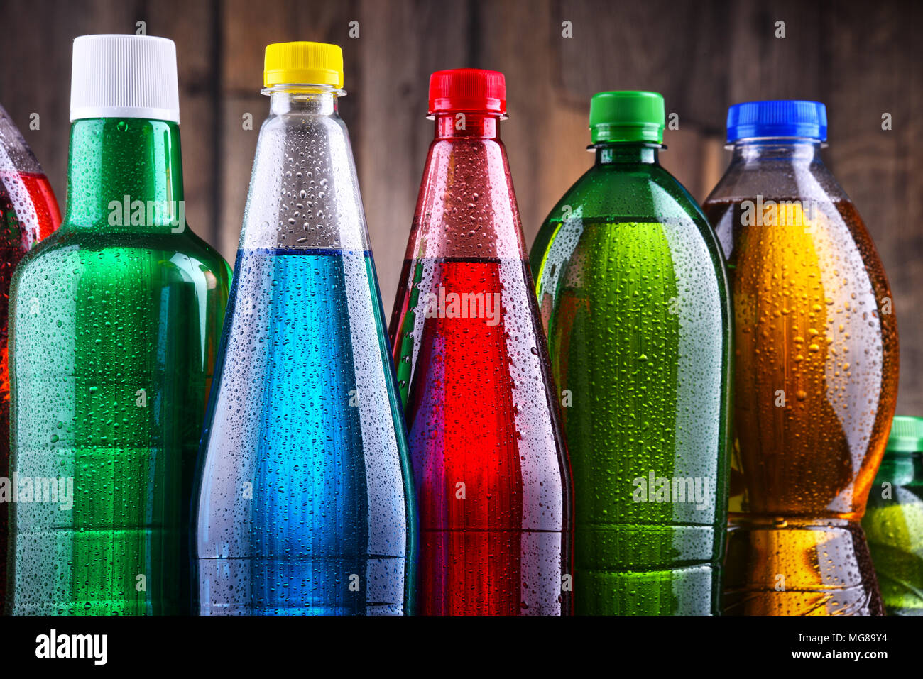 Plastic bottles of assorted carbonated soft drinks in variety of colors ...