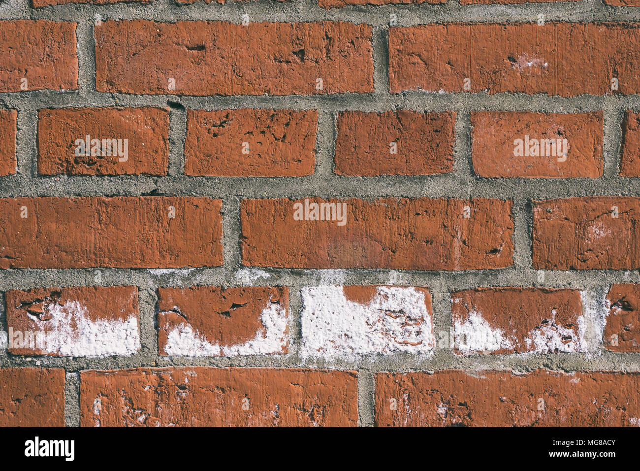 Close-up of brick wall with some white paint patches Stock Photo - Alamy