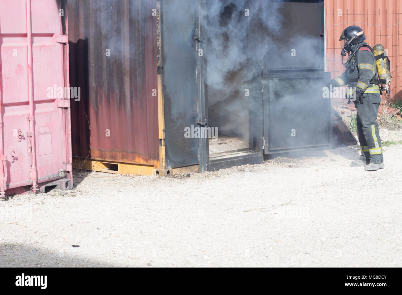 Firefighter putting out fire training station extinguisher backdraft ...