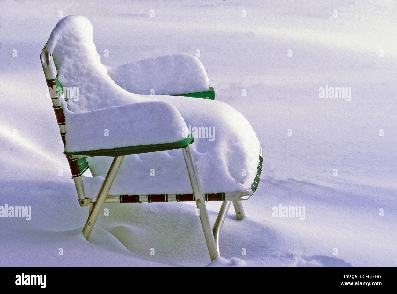 Meant to put this chair away before it snowed Stock Photo - Alamy