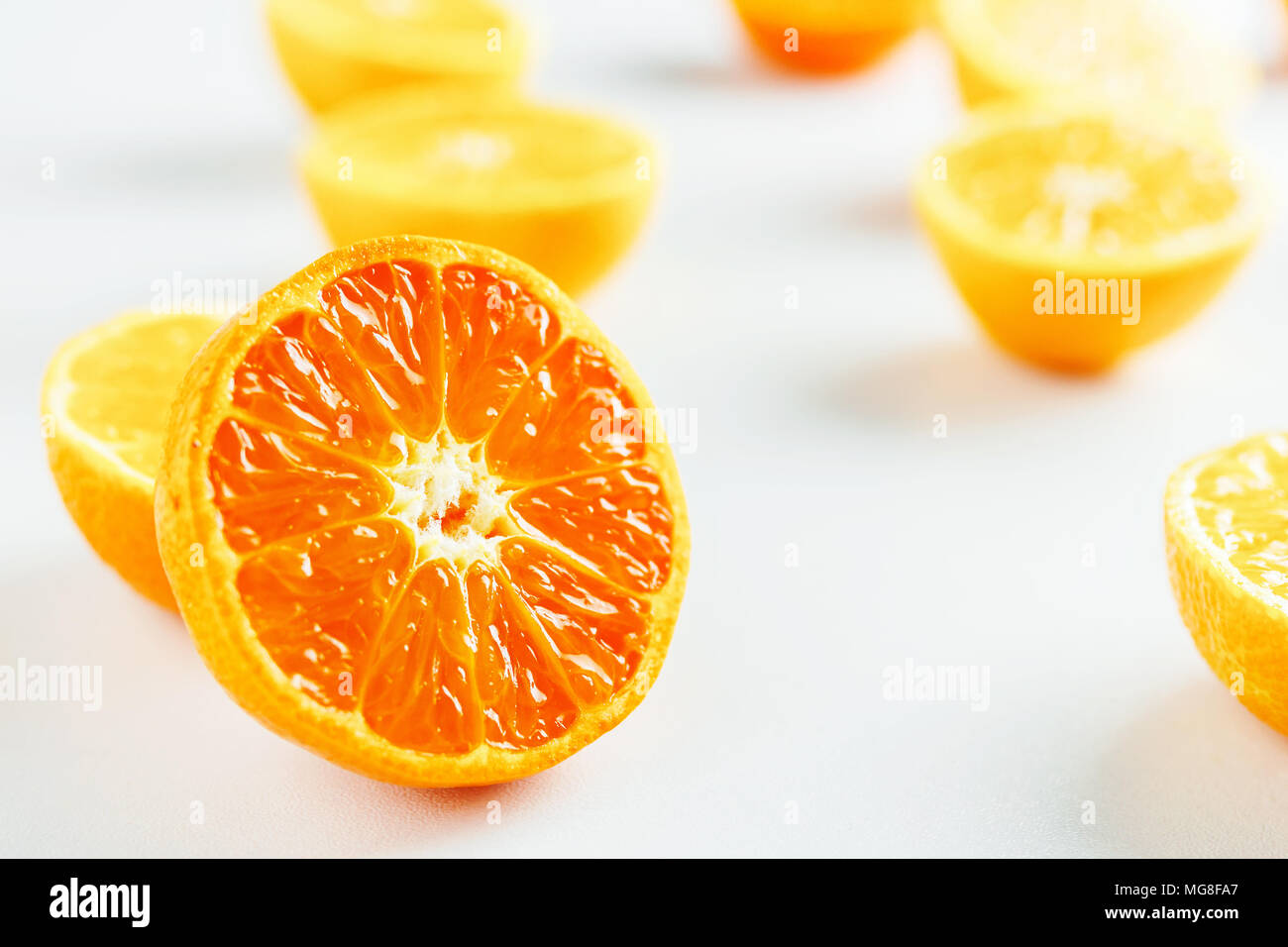 halves of tangerines on a white background pattern Stock Photo - Alamy