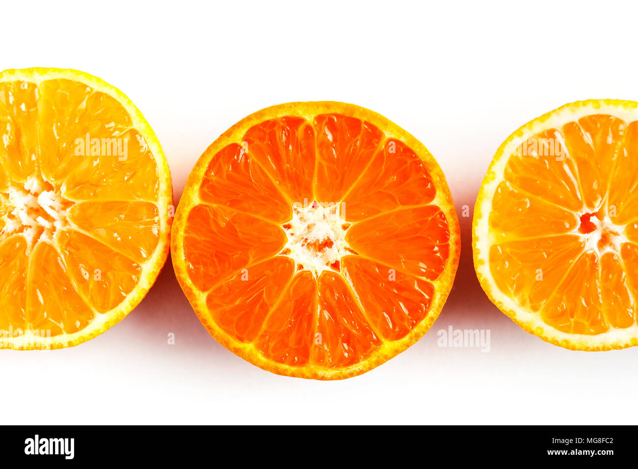 two yellow and red mandarins lie in a row on a white background of ...